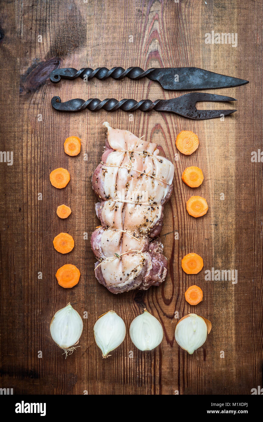 Raw roast pork preparation on rustic wooden background with cooking ...