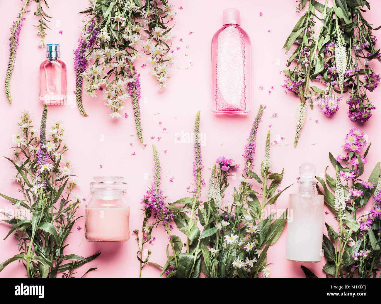Natural cosmetic products setting with various bottles and fresh herbs ...