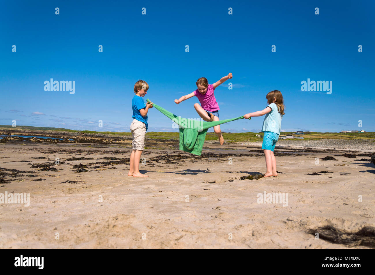Jumping on a beach hi-res stock photography and images - Alamy