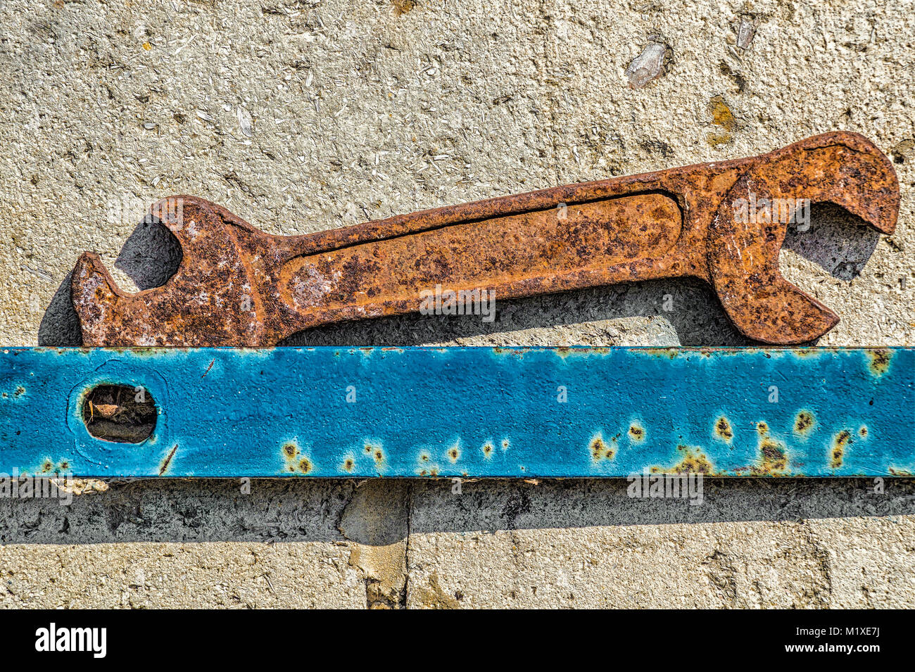 Old rusty wrench on the wall close-up Stock Photo - Alamy