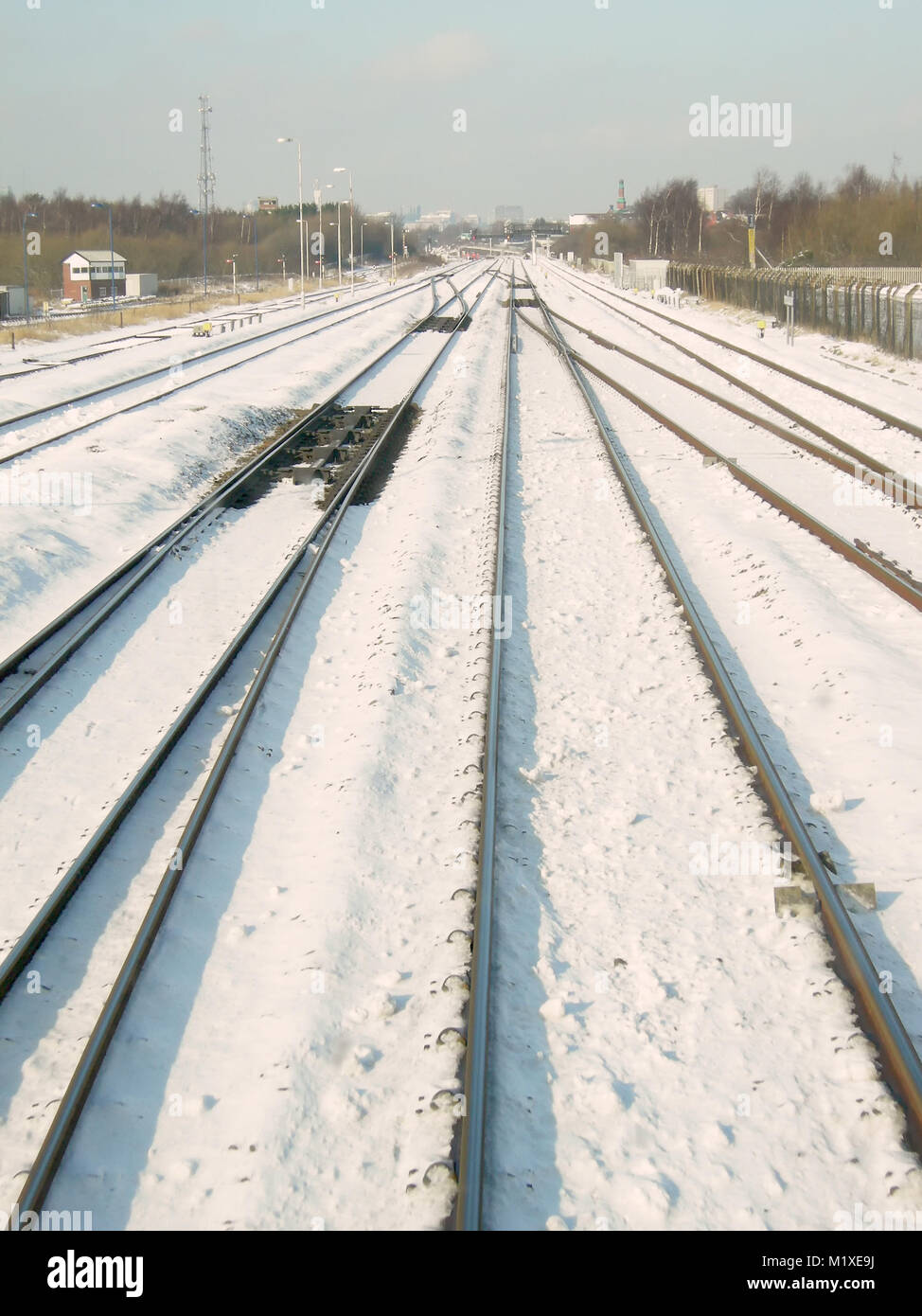 The railway line in the winter snow in the West Midlands of England ...
