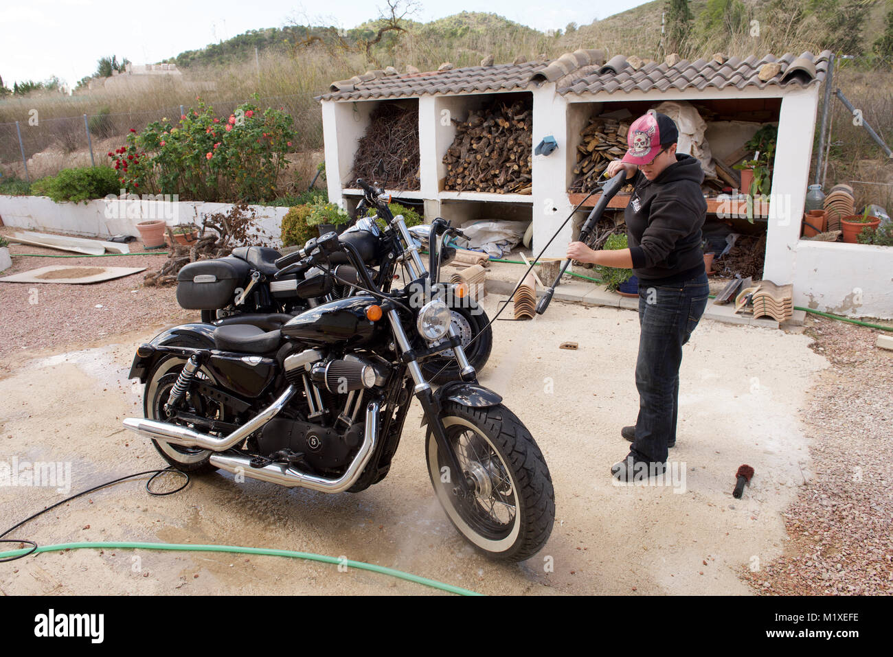 Washing two Harley Davidson motorcycles with a jet wash Stock Photo - Alamy