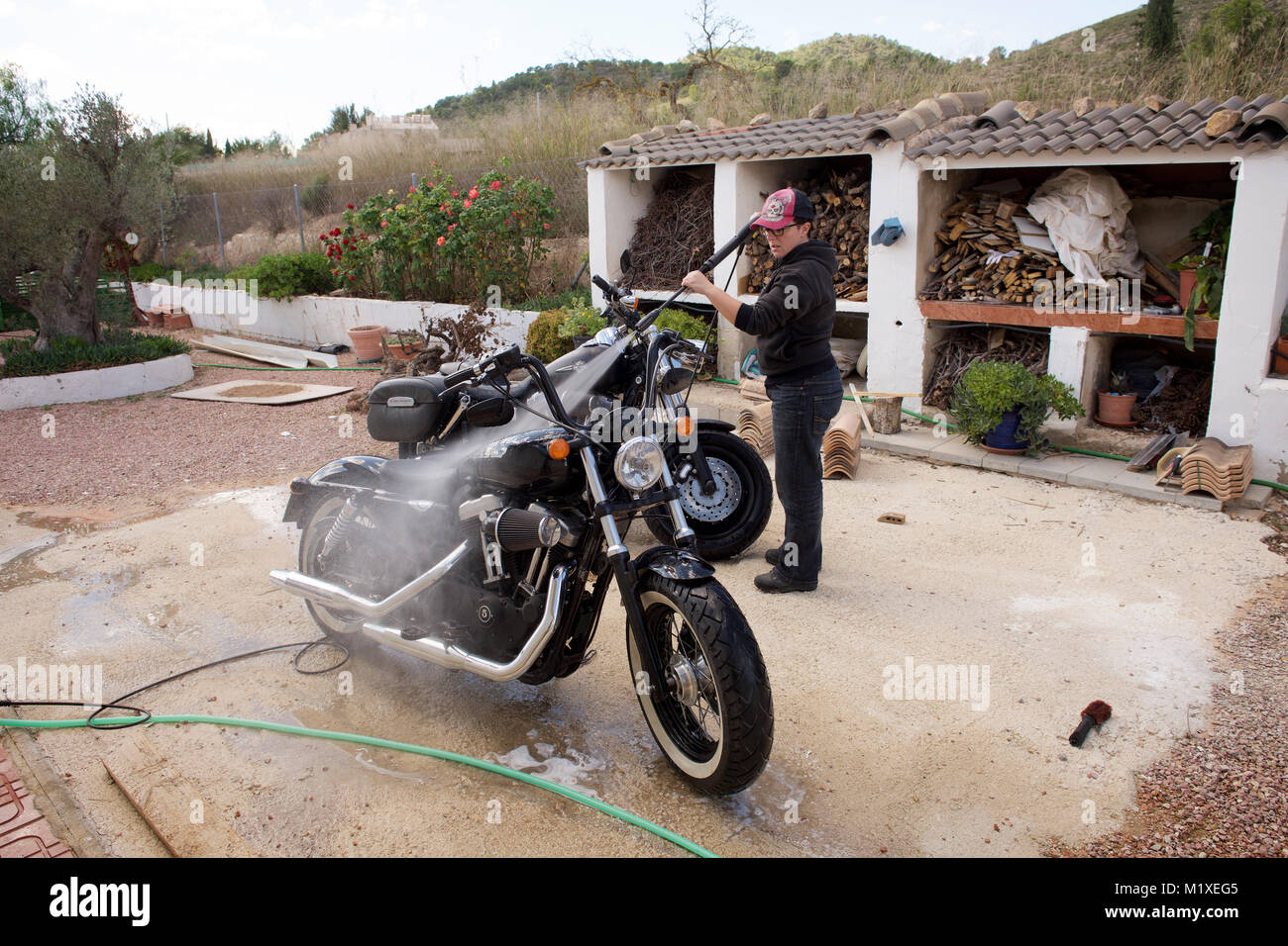 Washing two Harley Davidson motorcycles with a jet wash Stock Photo - Alamy