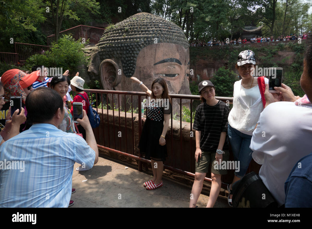 People and tourists at the Leshan Giant Buddha in Leshan, Sichuan ...
