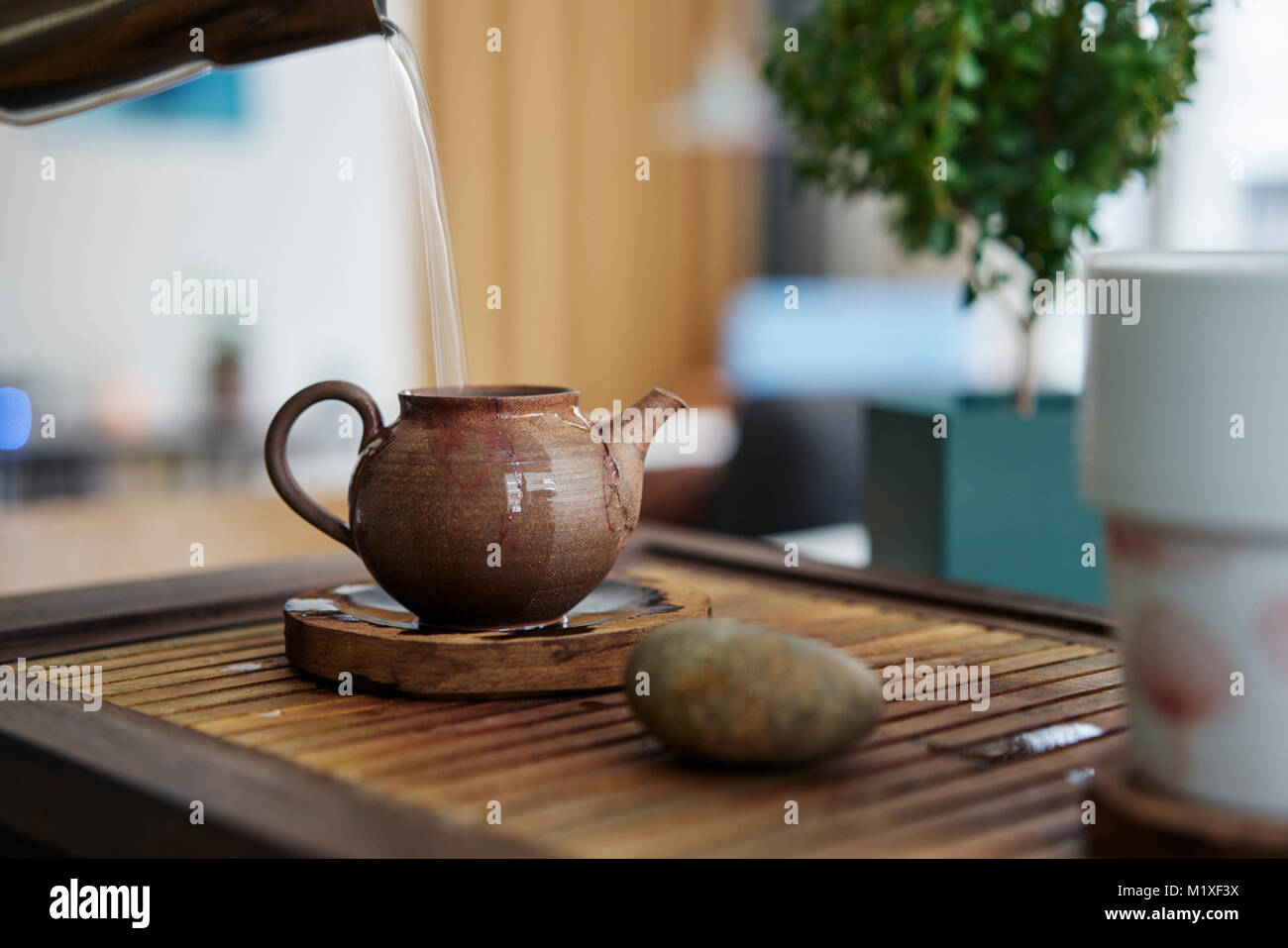 Water pouring into teapot Stock Photo - Alamy