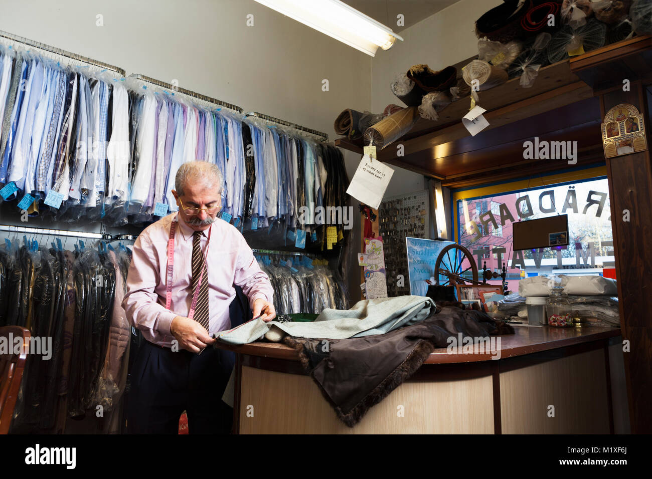 Man sewing garment Stock Photo - Alamy