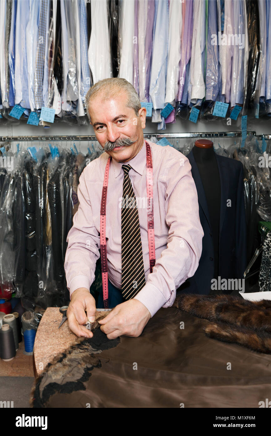 Man sewing garment Stock Photo - Alamy