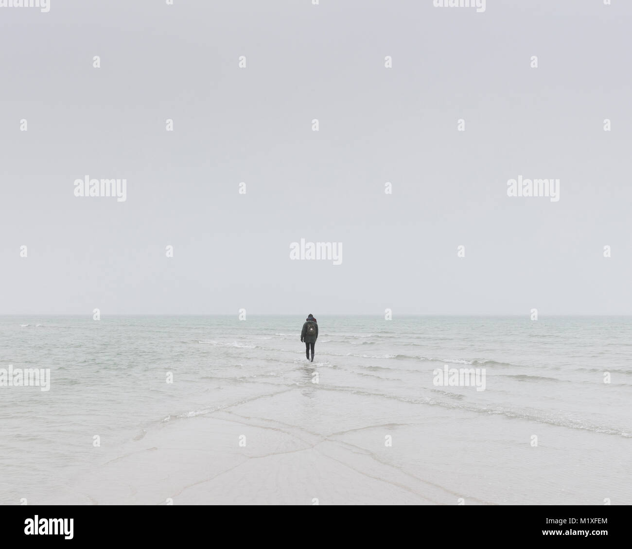 Person walking on beach during winter in Falsterbo, Sweden Stock Photo ...