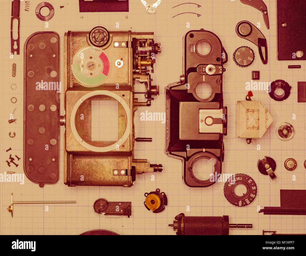 parts are completely disassembled old retro film SLR camera on graph ...
