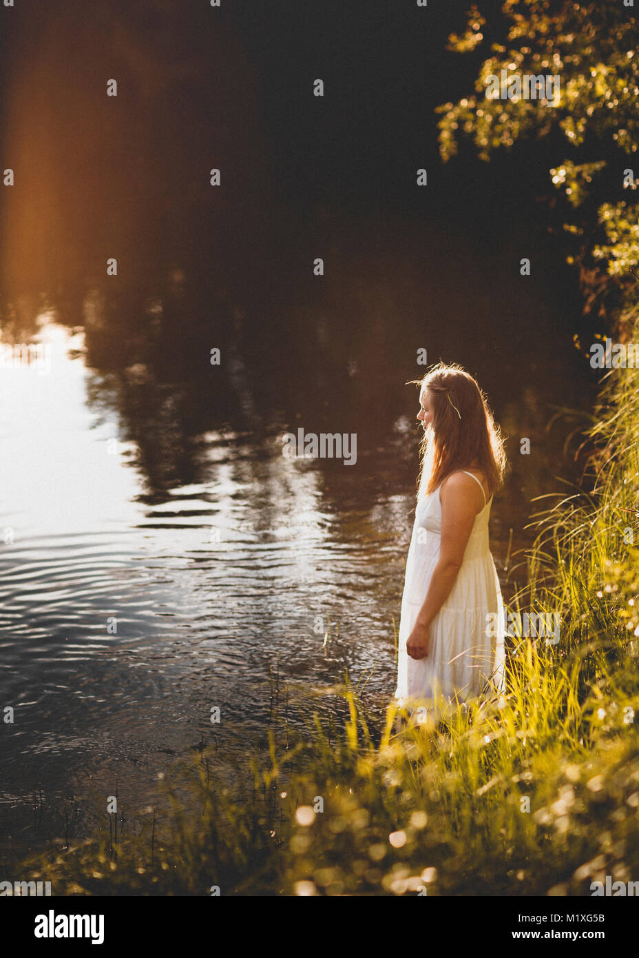 Woman in dress wading in water hi-res stock photography and images - Alamy