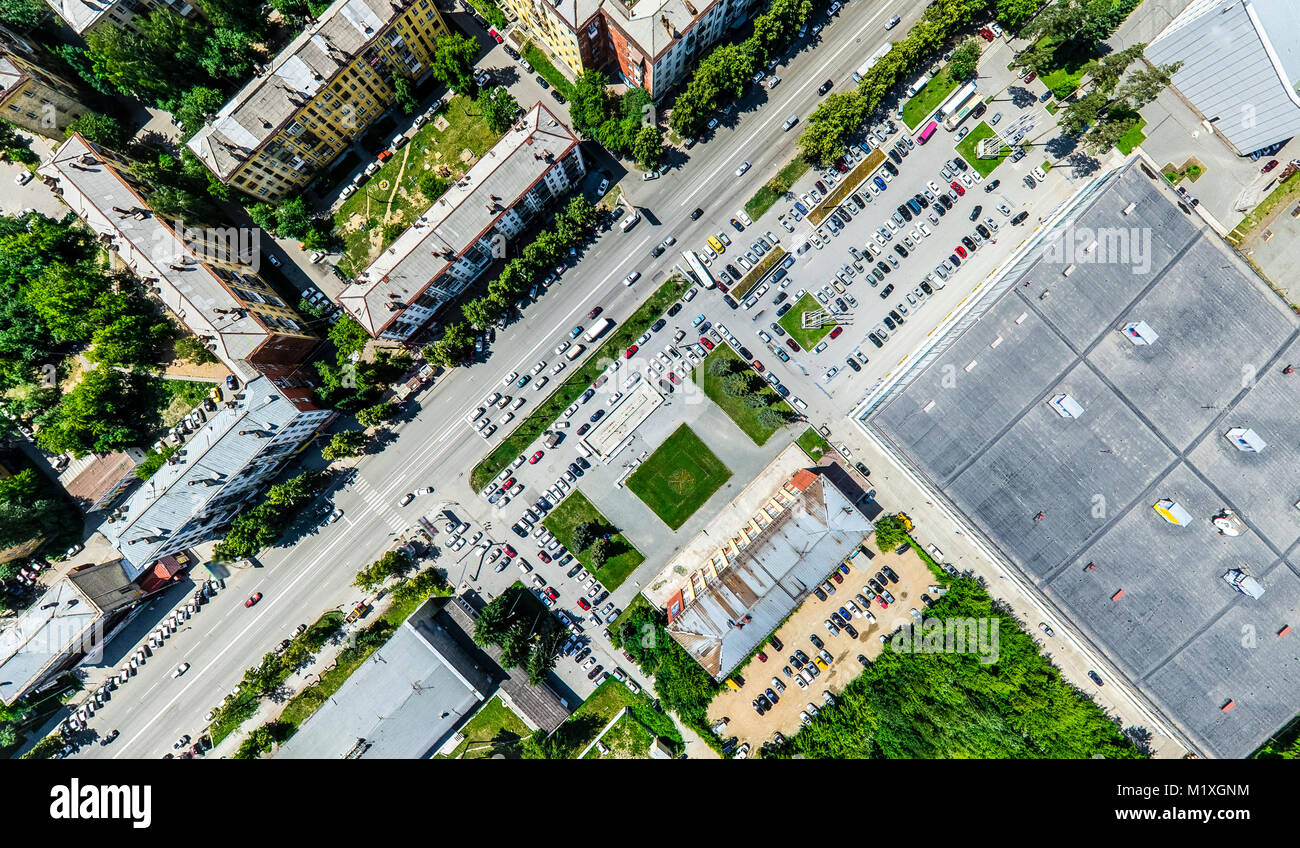 Aerial city view with crossroads and roads, houses, buildings, parks ...