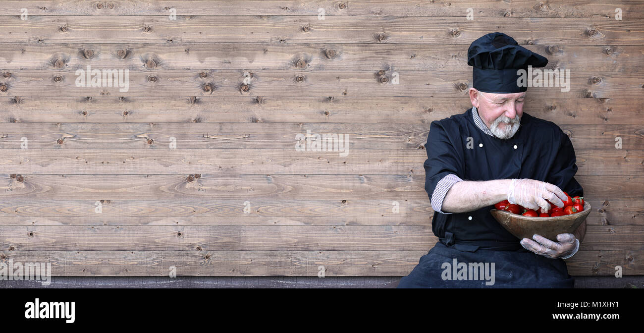 Chef old in uniform with vegetables Stock Photo - Alamy