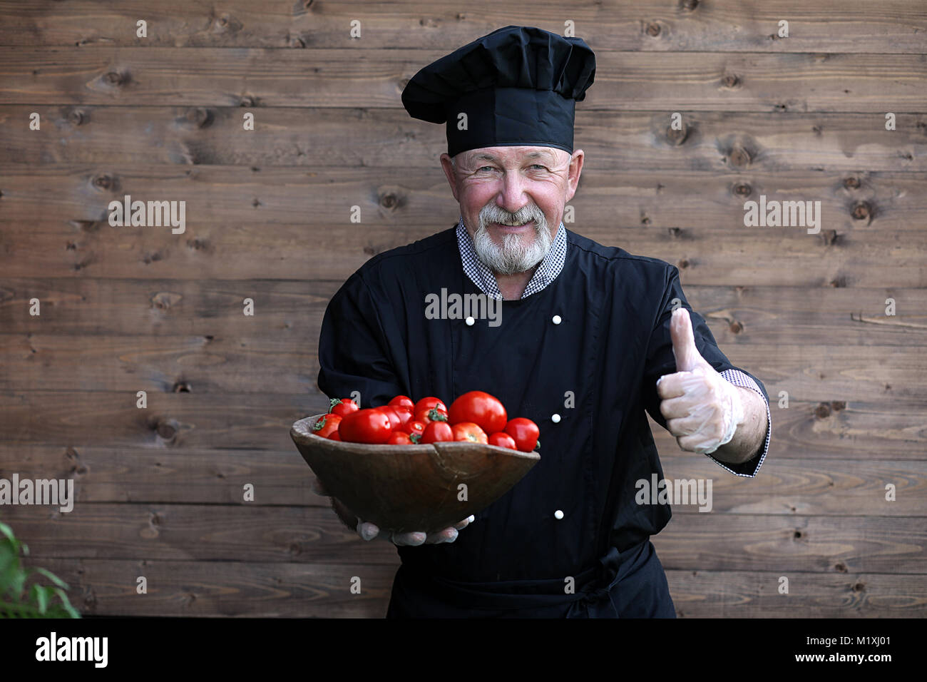 Chef old in uniform with fresh vegetables Stock Photo - Alamy
