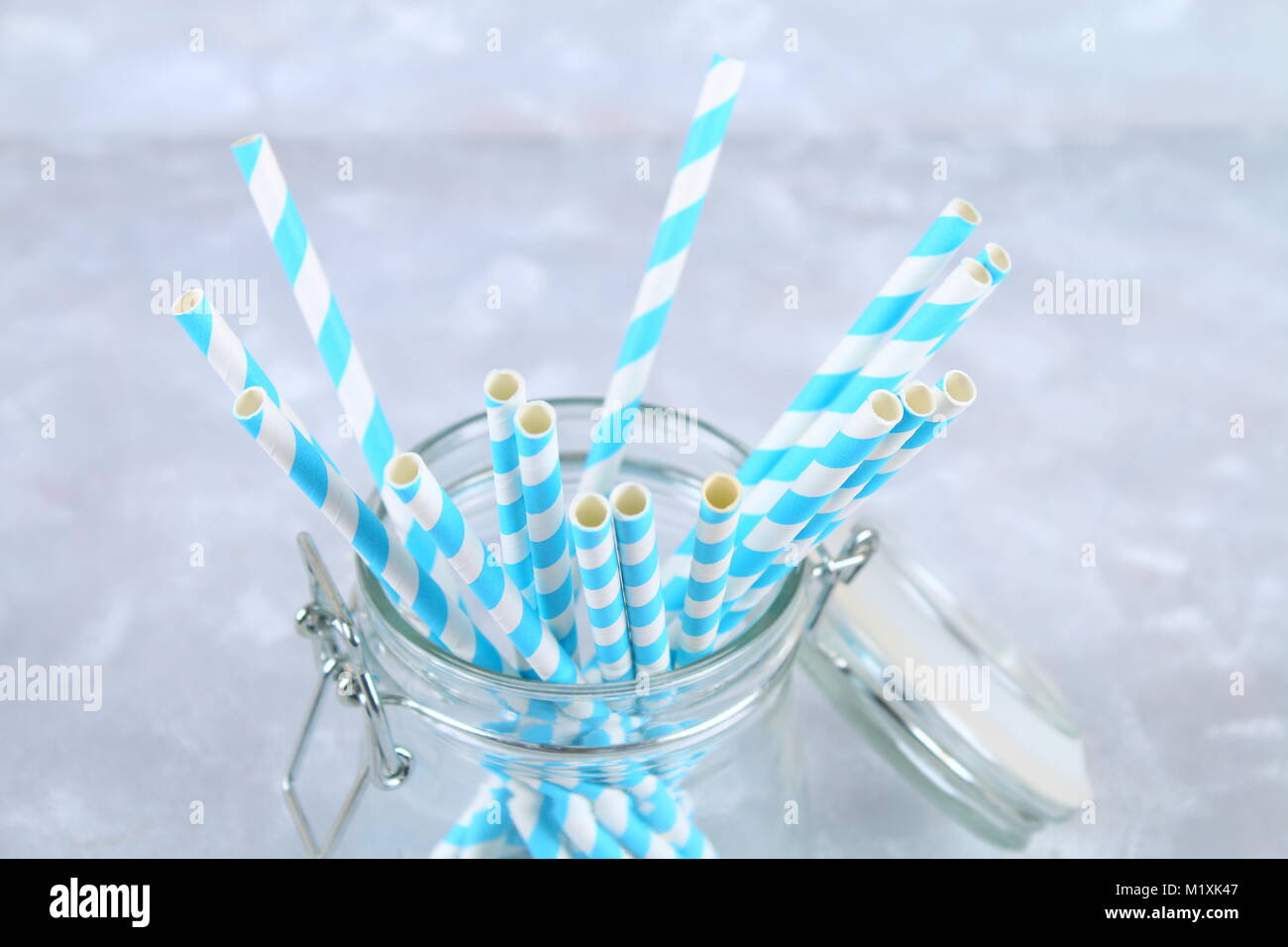 Blue striped paper disposable tubes in a jar on a gray background Stock ...