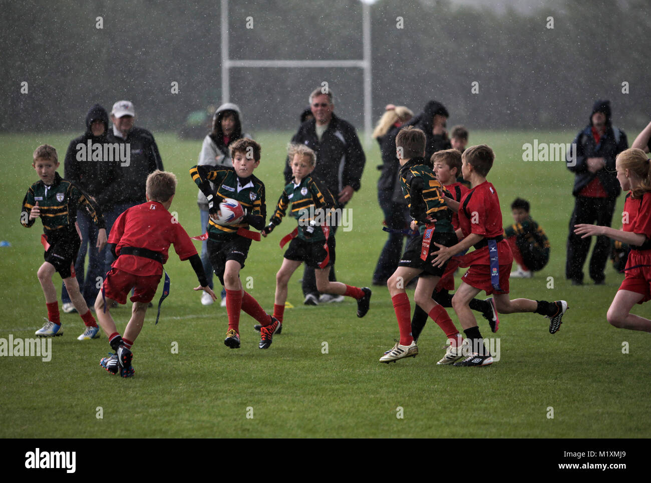 Girls and boys playing Tag Rugby in The midlands on a rainy Afternoon ...
