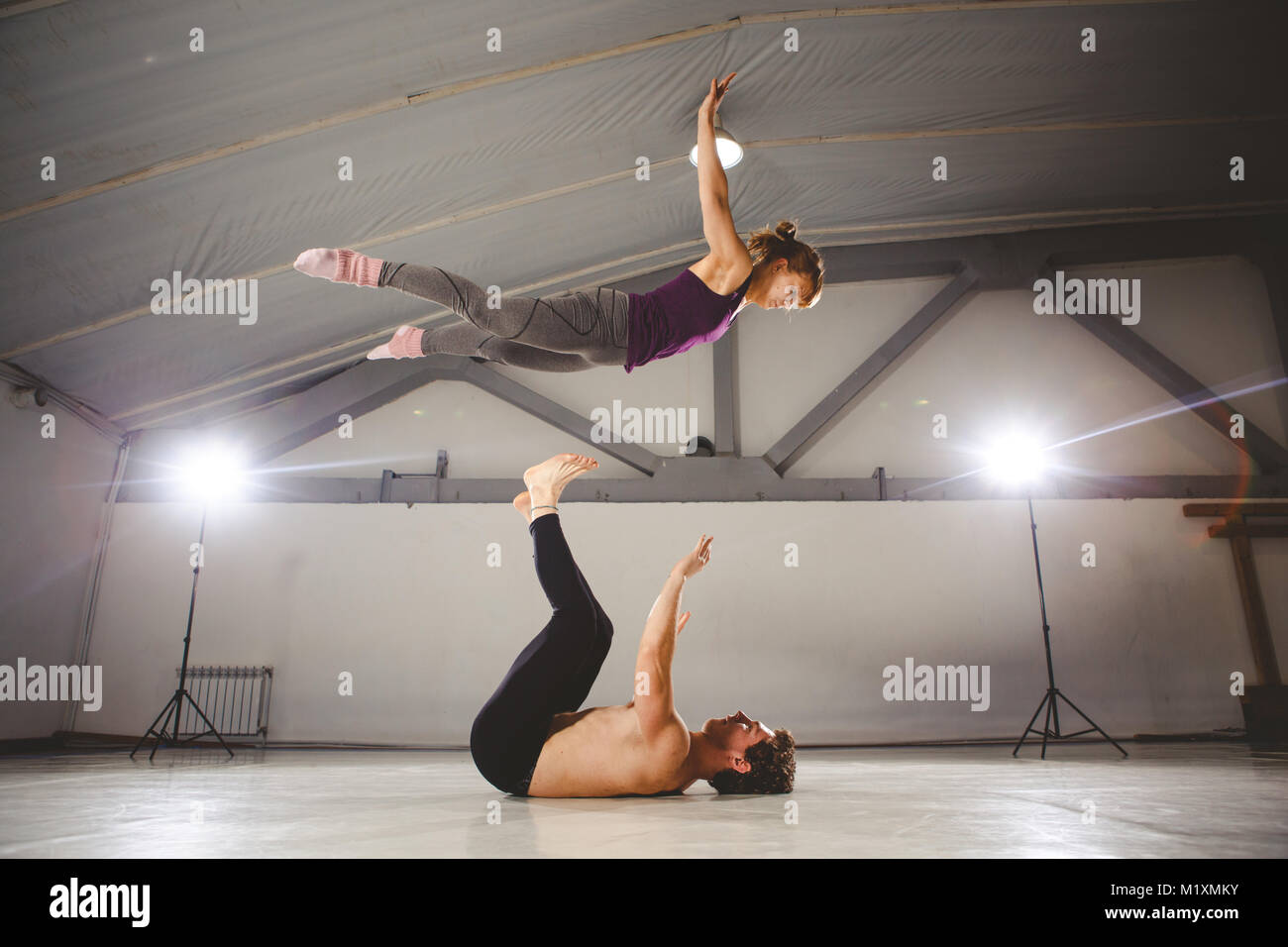 Strong acrobatic woman lifting man hi-res stock photography and images ...
