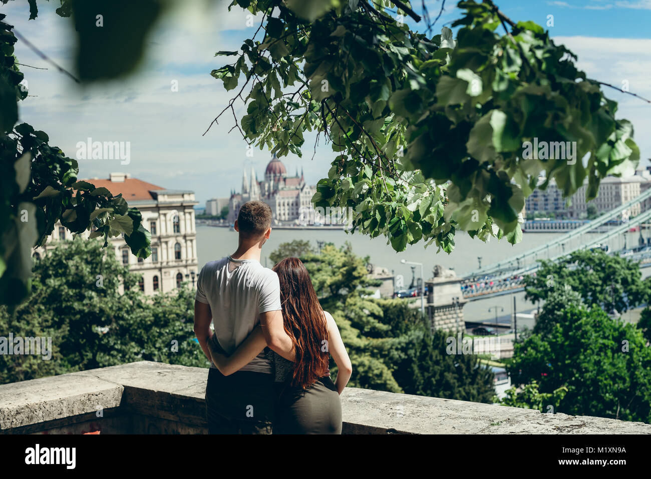 Back view portrait of the beautiful loving couple hugging while ...