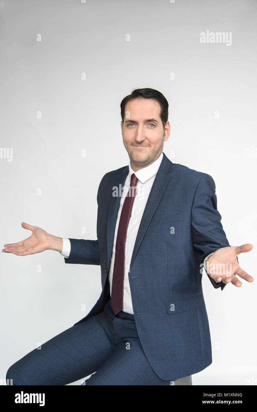 A smartly dressed man conveys a range of facial and bodily emotions ...