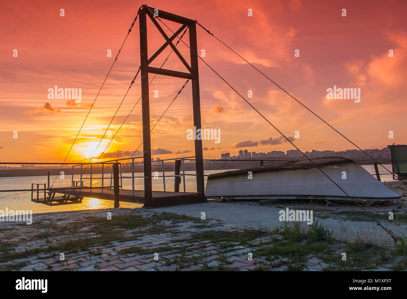 Small Boat Near the Wooden Pier that suspended with Sunset Stock Photo ...