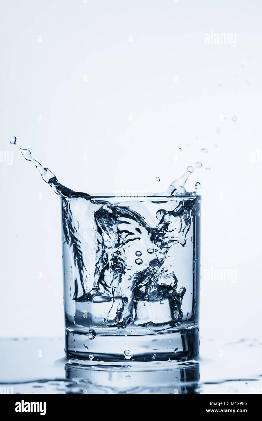 Ice cubes are dropping in to the glass of pure water Stock Photo - Alamy