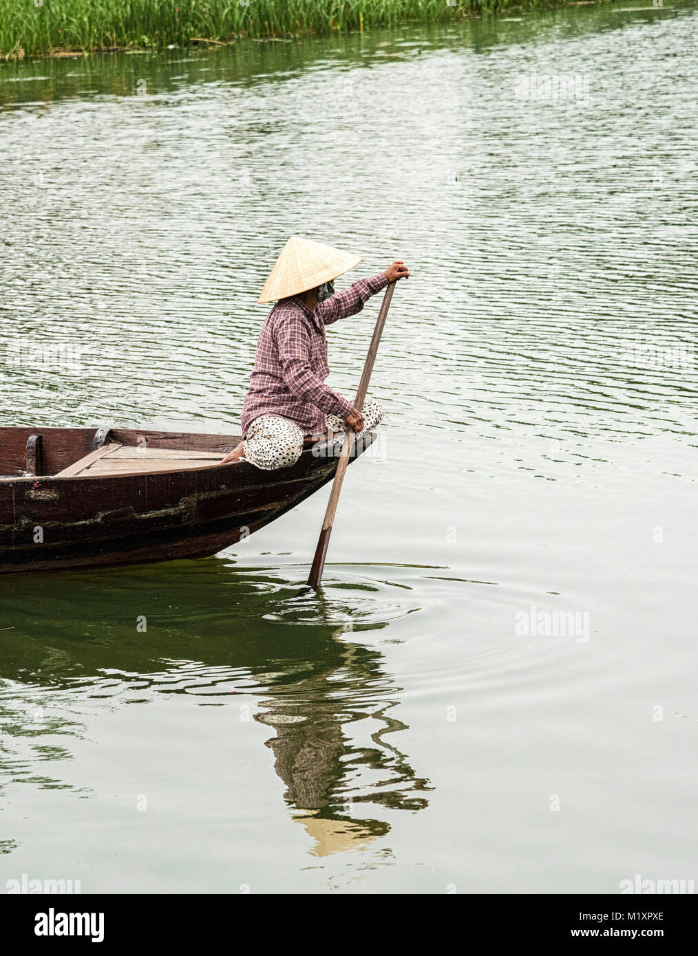 Traditional Vietnamese lady everyday life in small boat crossing a ...