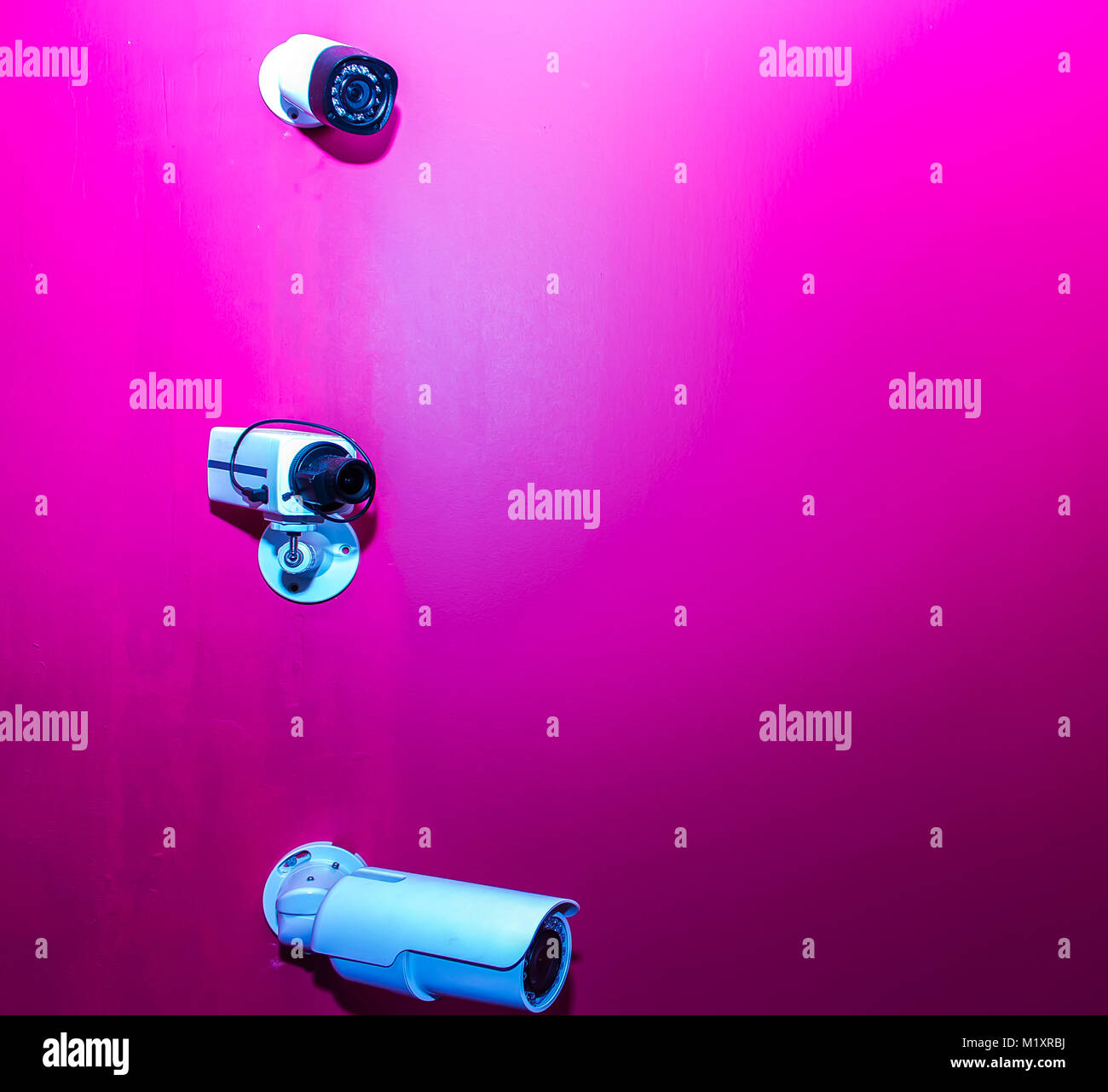 CCTV Security Camera Over The Pink Wall Stock Photo - Alamy