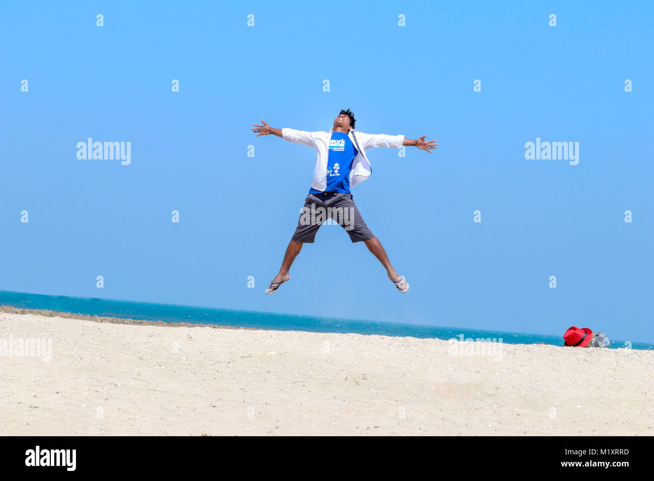 Asian young man floating mid air with crazy Stock Photo - Alamy