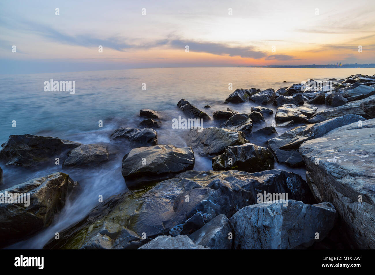 Empty sea and rocks During the sunset with Silky Sea beacuse of the ...