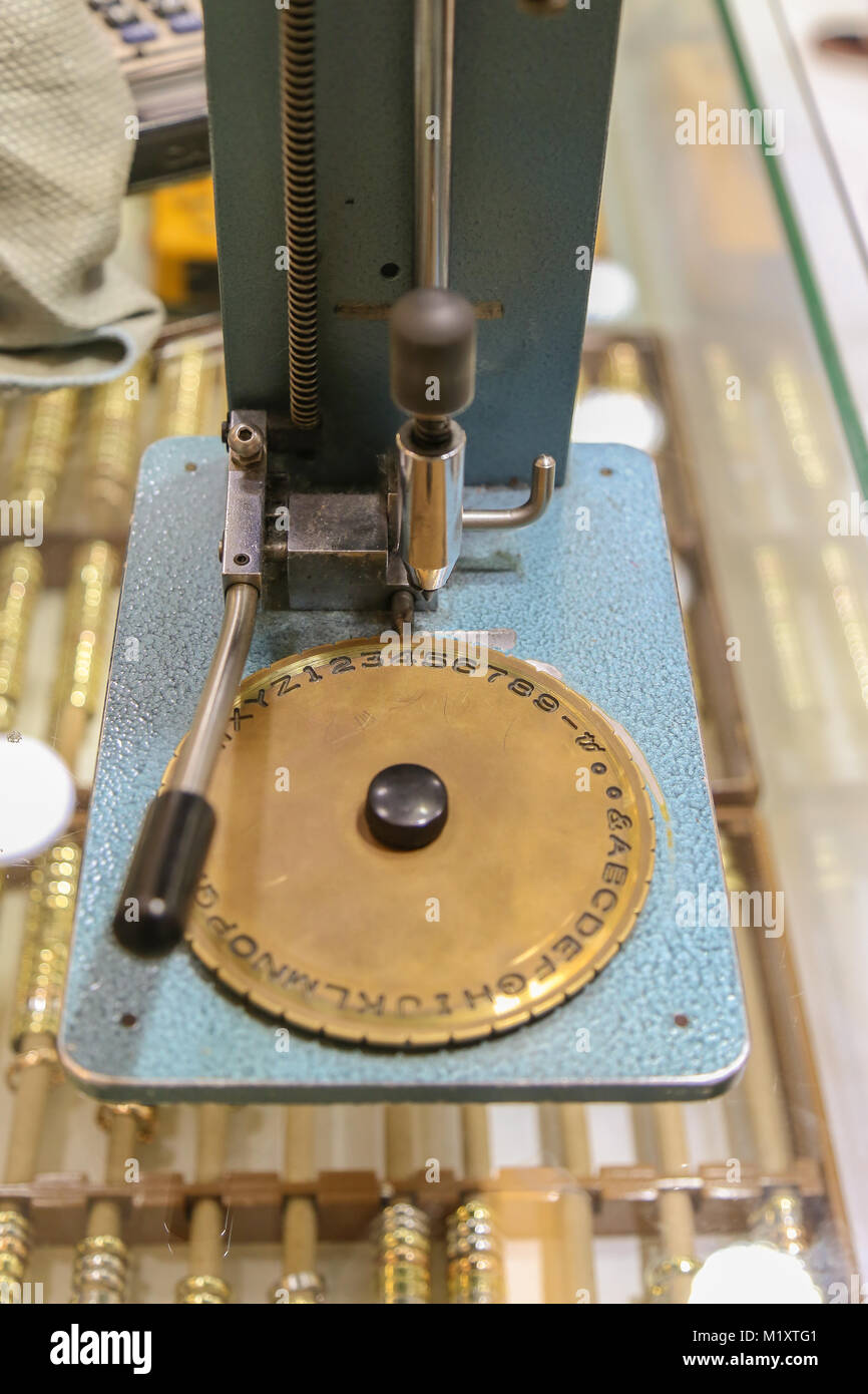 Manuel gravograph machine that performs writing article or number onto ...