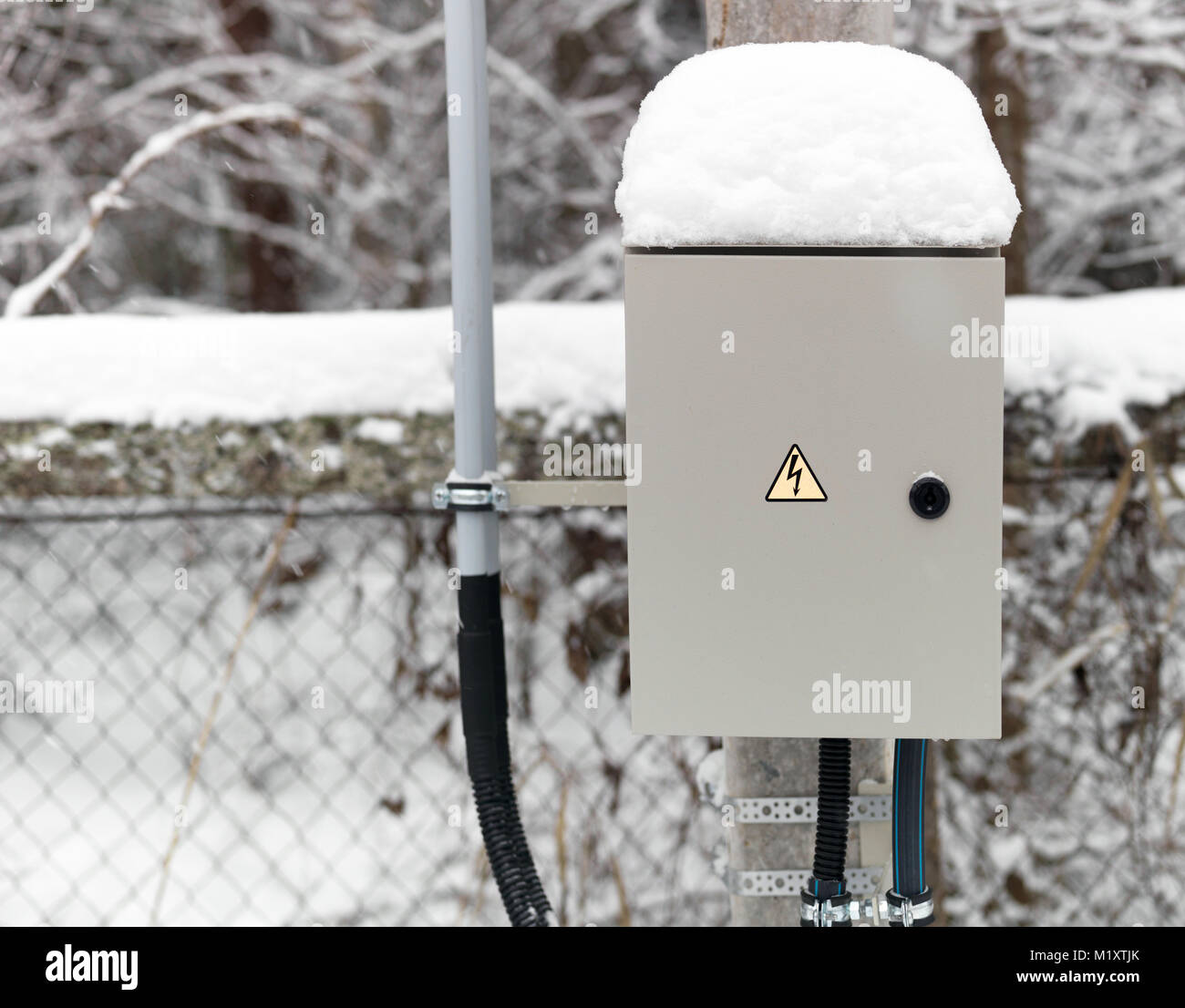 Electrical control box with a danger sign installed outside, winter ...