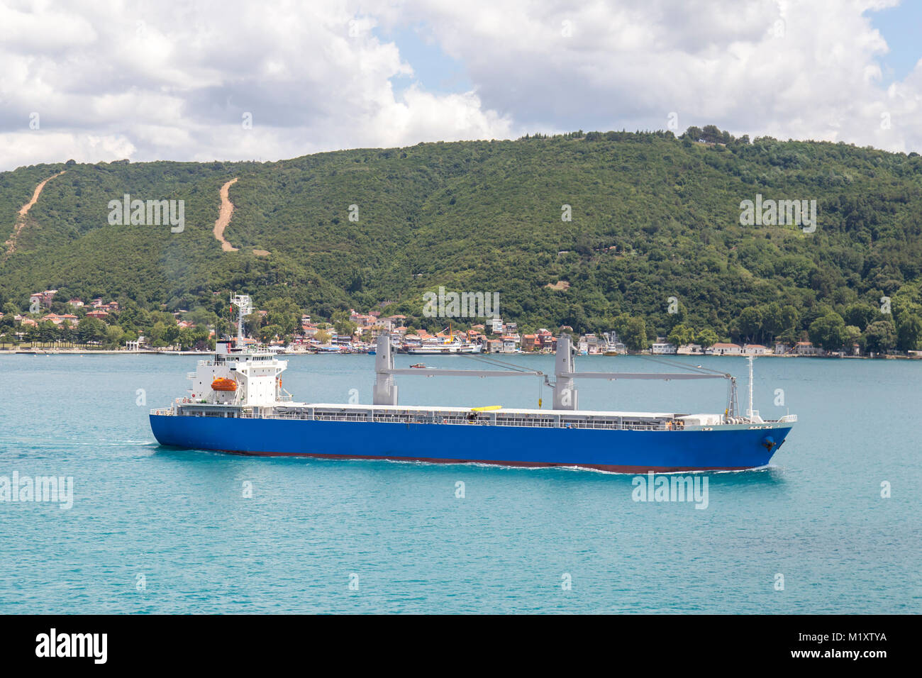 Big size freighter ship in sunny day Stock Photo - Alamy
