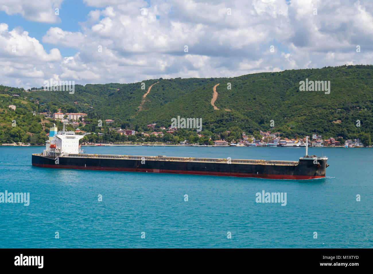 Big size freighter ship in sunny day Stock Photo - Alamy