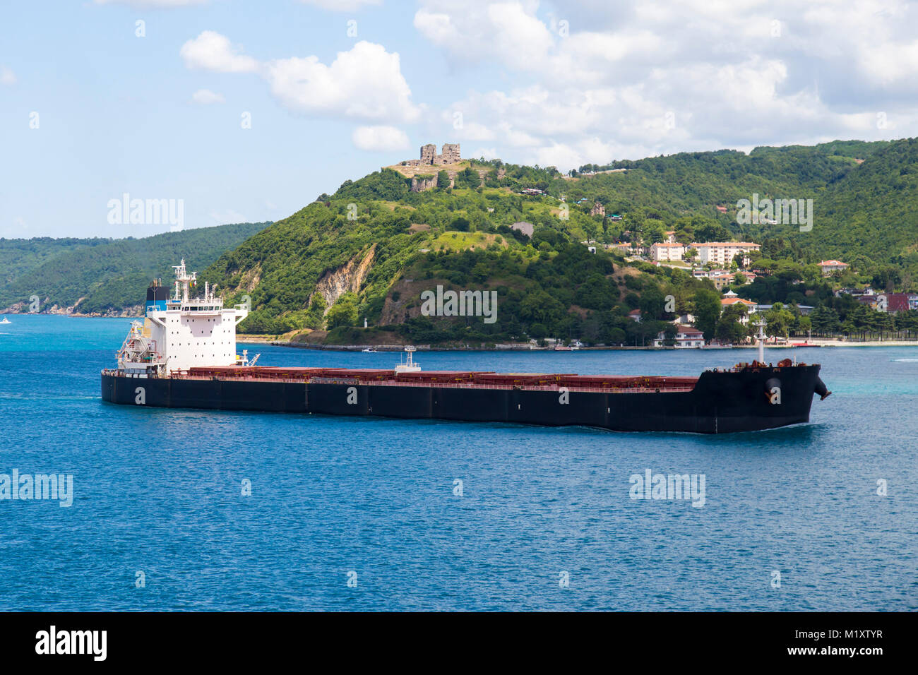 Big size freighter ship in sunny day Stock Photo - Alamy