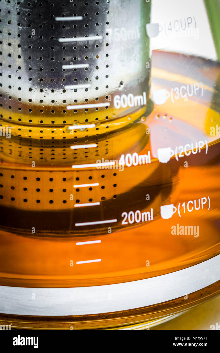 Modern teapot made of glass with a grid inside Stock Photo - Alamy