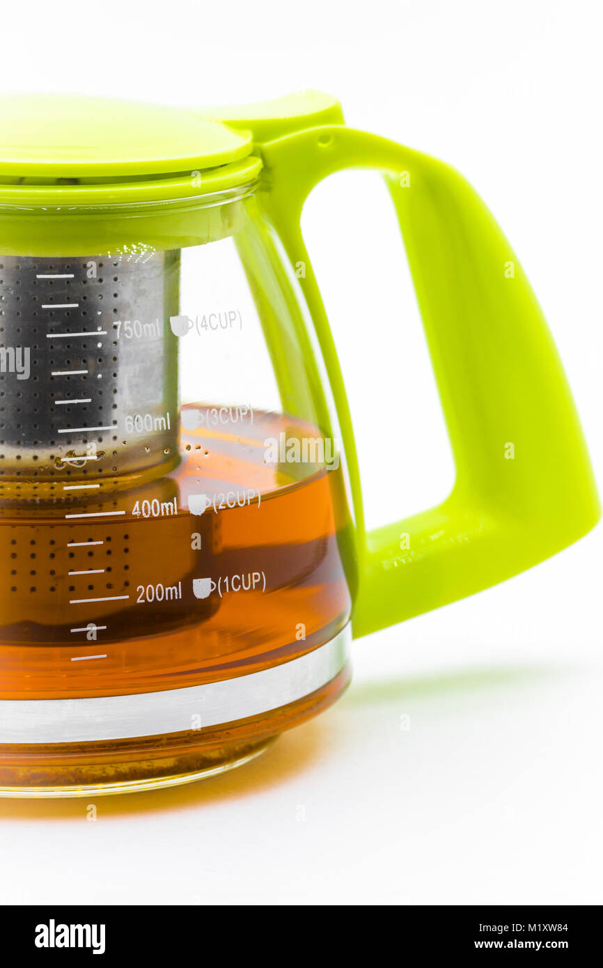 Modern teapot made of glass with a grid inside Stock Photo - Alamy