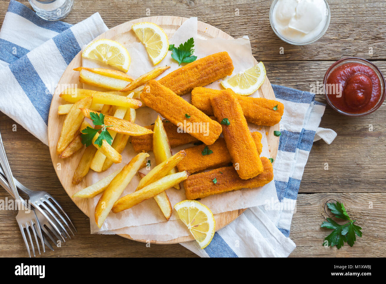 Fried Fish Sticks with French Fries. Fish Fingers over wooden ...