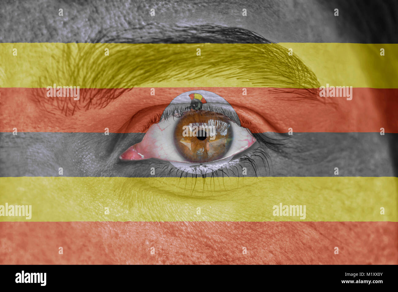 Human face and eye painted with flag of Uganda Stock Photo - Alamy