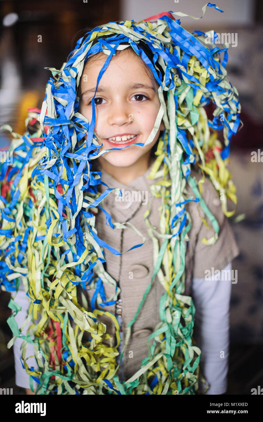 child little girl with streamers around his neck and head for the ...