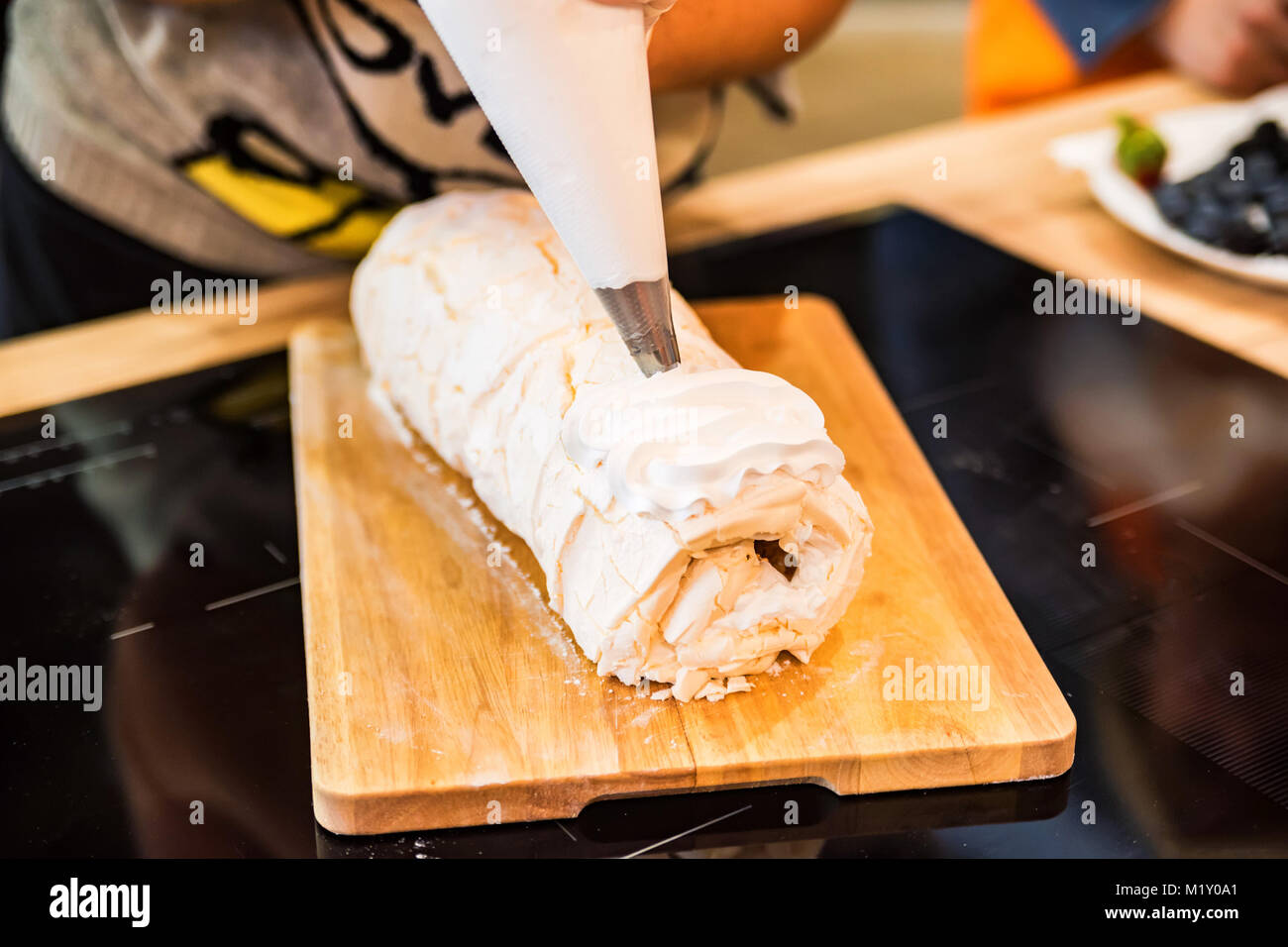 Making white swiss roll close Stock Photo - Alamy