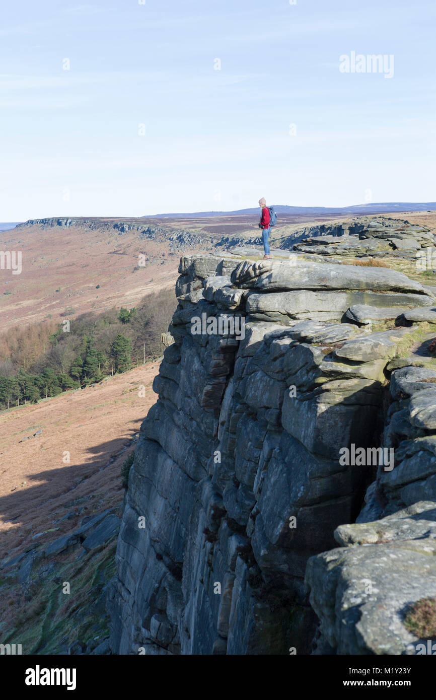 UK, Derbyshire, Peak District Nationa Park, a walker on the cliff edge ...