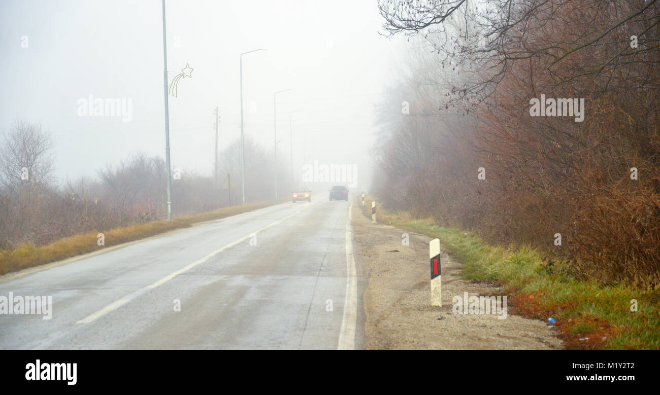 An asphalt road with fog in winter,image of a Stock Photo - Alamy