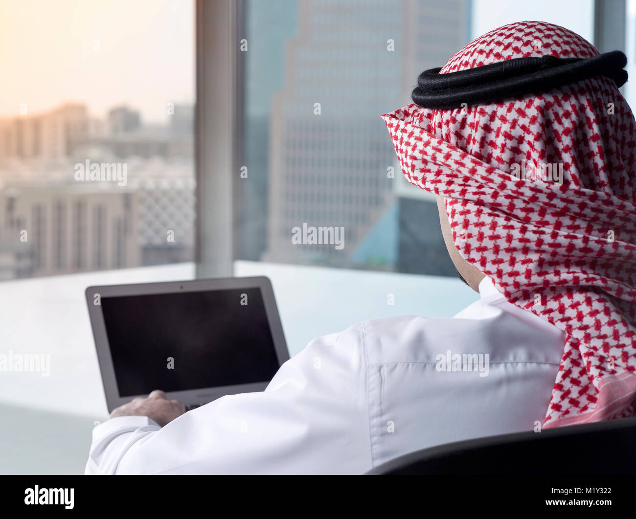 Saudi Arab Man Watching Laptop at Work and Contemplating Stock Photo ...