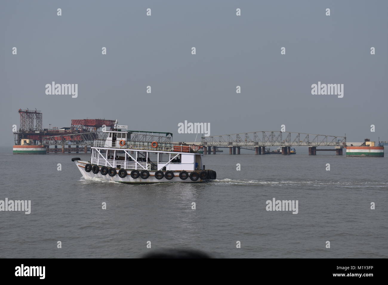 A view of a boat on sea drive & looking a refinery plant at sea at ...
