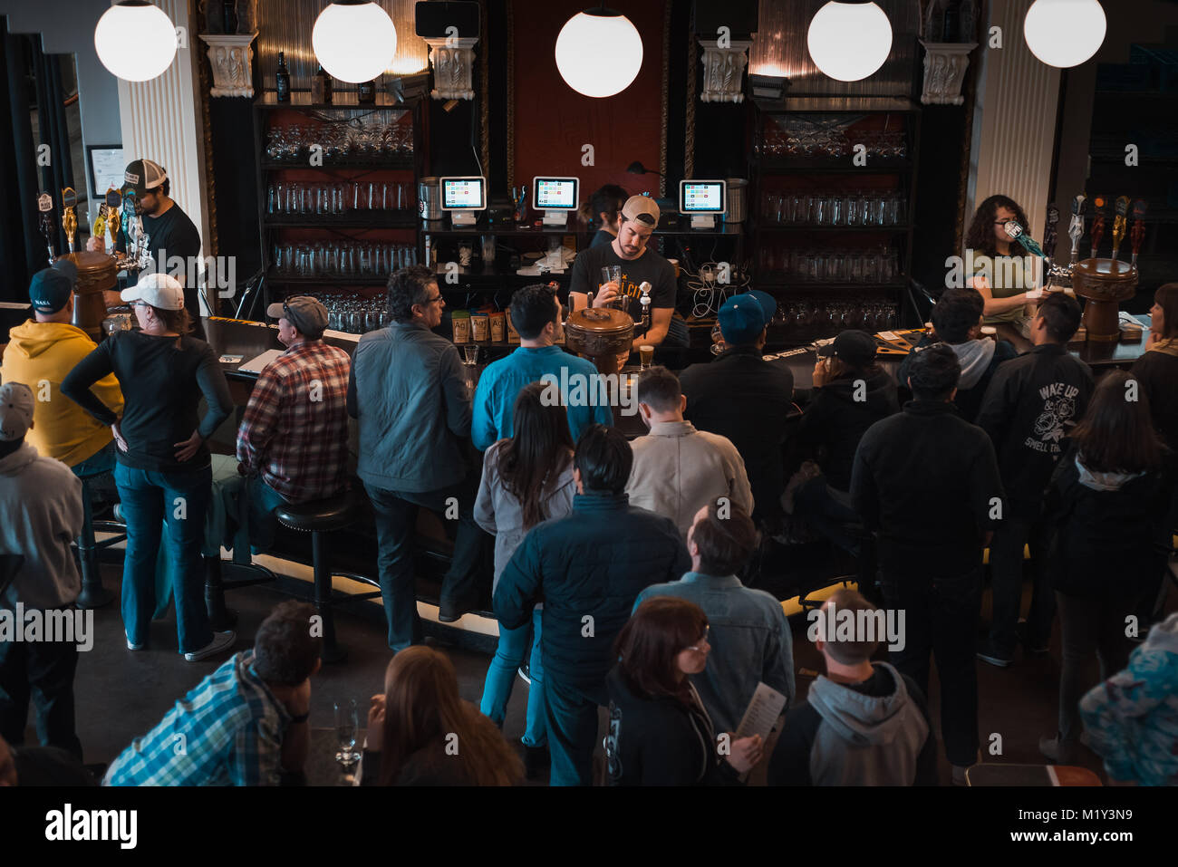 Customers lined-up to get an ice cold beer at a small independent ...