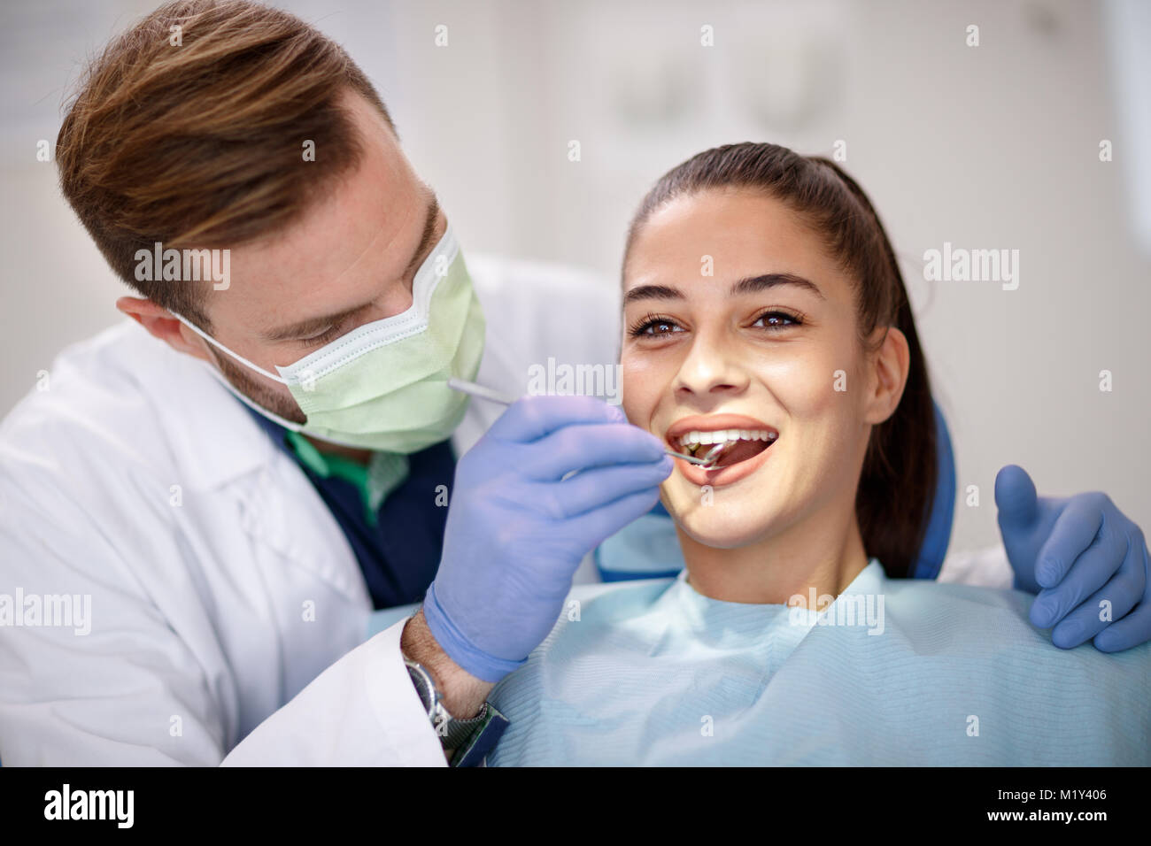 Dentist checking up female’s teeth with mirror Stock Photo - Alamy