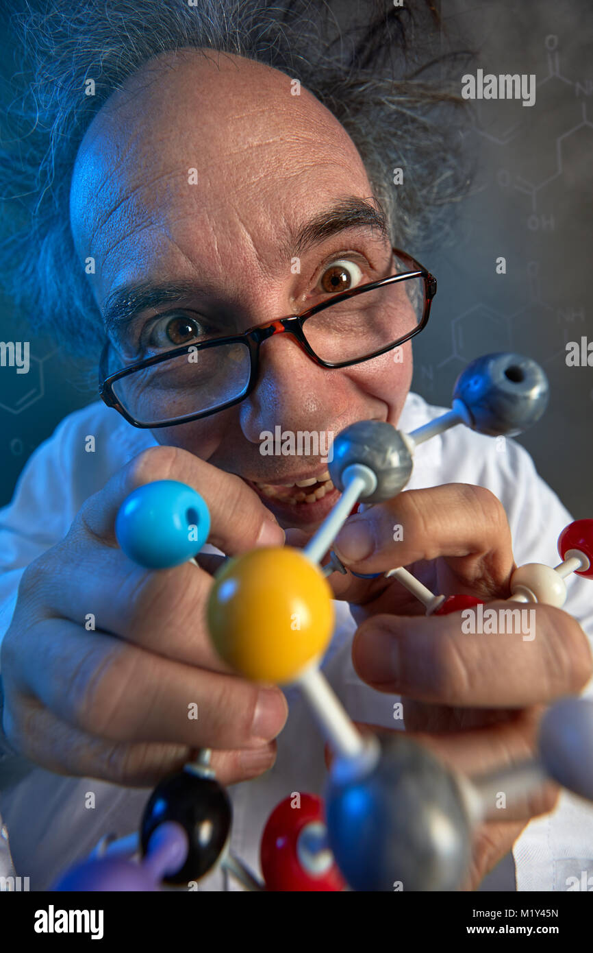Crazy scientist with model molecules building a new chemical compound ...