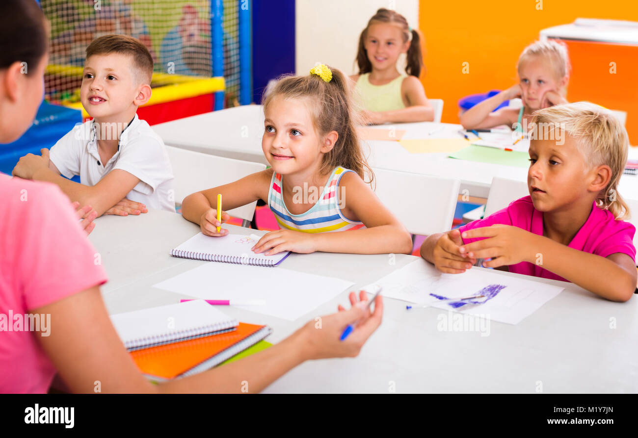 european children sitting together and studying in class at school ...