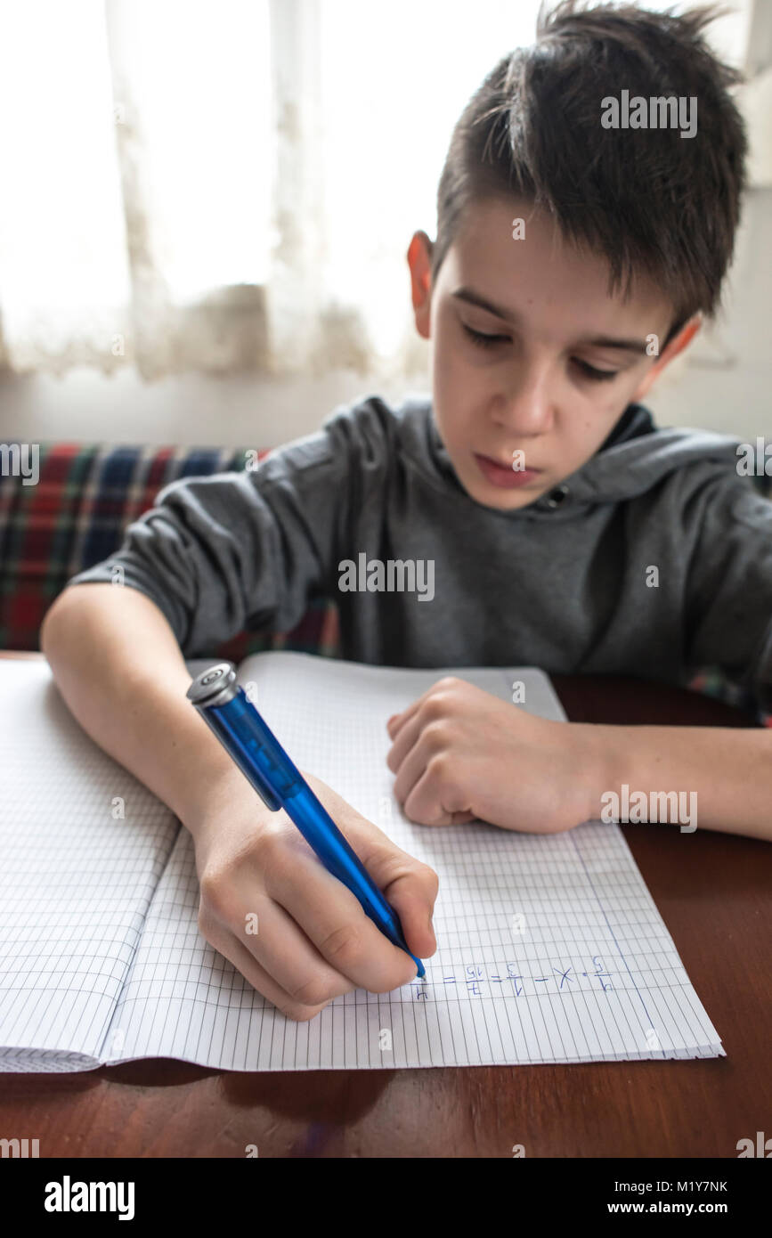 Boy do his homework. Notebook Stock Photo - Alamy