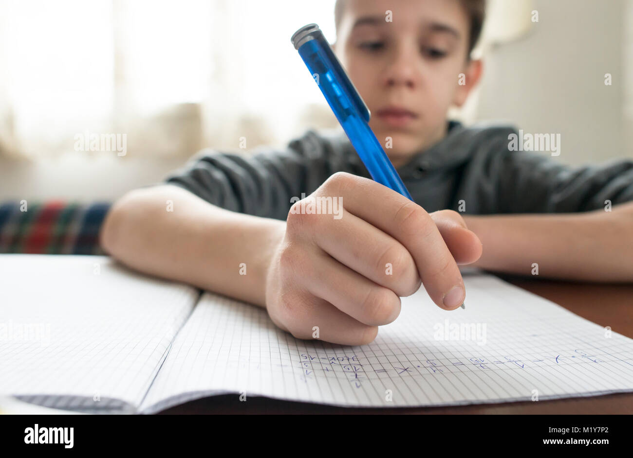 Boy do his homework. Notebook Stock Photo - Alamy