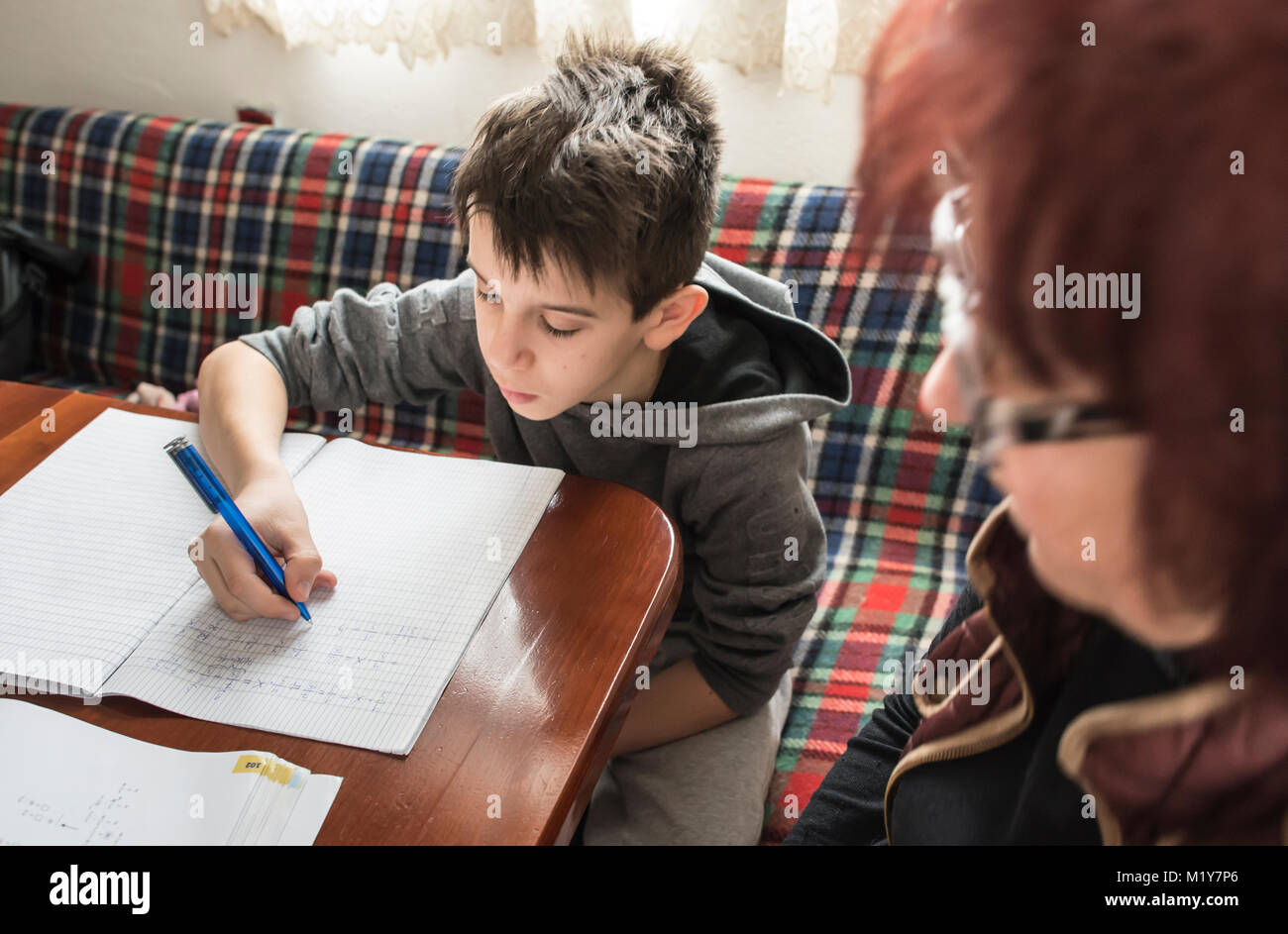 Boy do his homework. Notebook Stock Photo - Alamy